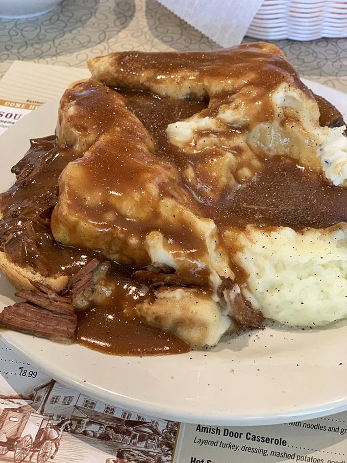 This isn't just roast beef—it's a gravy waterfall cascading over mashed potato mountains. Comfort food architecture at its finest.