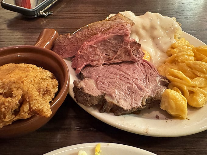 Behold the star attraction: perfectly pink roast beef alongside creamy mashed potatoes and mac & cheese—a holy trinity of comfort that makes grown adults weak in the knees.