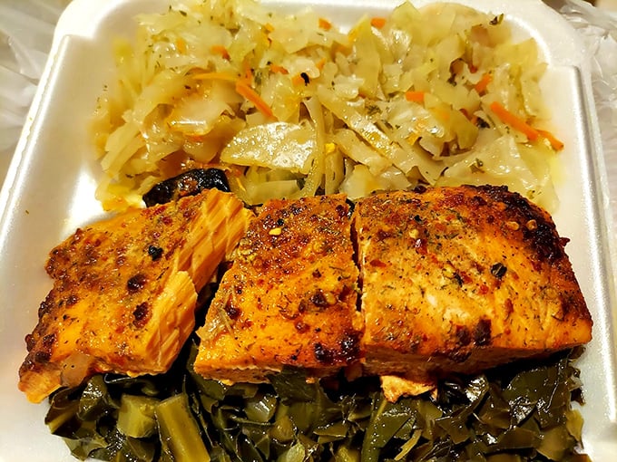This salmon platter isn't just dinner—it's edible poetry. Perfectly seasoned fish nestled between cabbage and collard greens creates a harmony of flavors that sings.