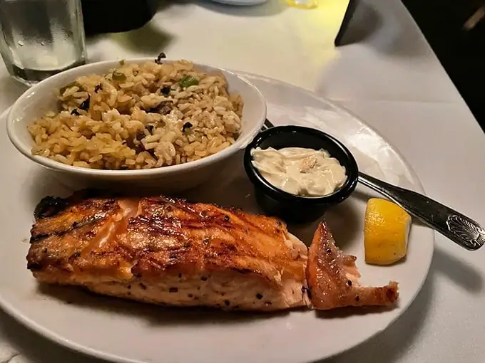 That salmon arrives with the kind of char marks that would make a grill master weep with joy.