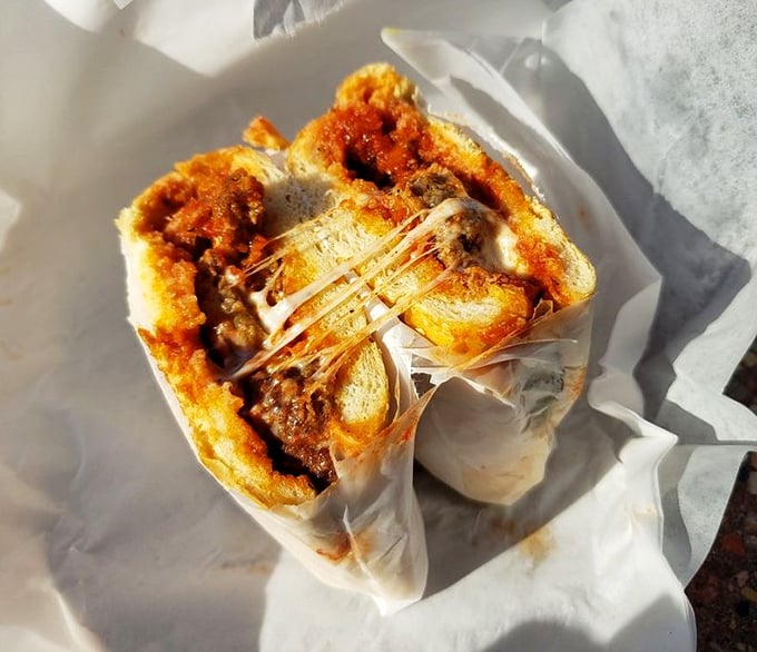 Behold the meatball sandwich that defies physics – somehow staying together despite its glorious, sauce-dripping abundance.