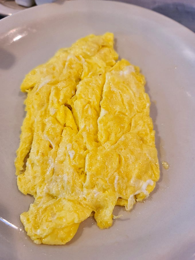 Sunshine on a plate! These cloud-like scrambled eggs achieve that perfect balance of fluffy and substantial—the diner holy grail.