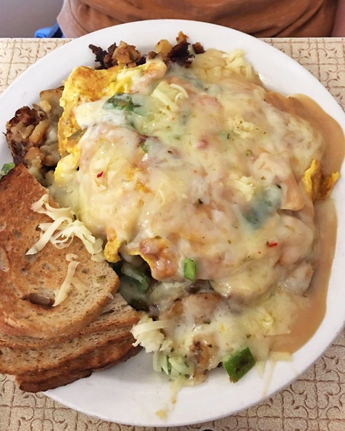 The legendary Scrambler isn't just breakfast—it's a topographical marvel of eggs, potatoes, and gravy that requires both strategy and commitment.