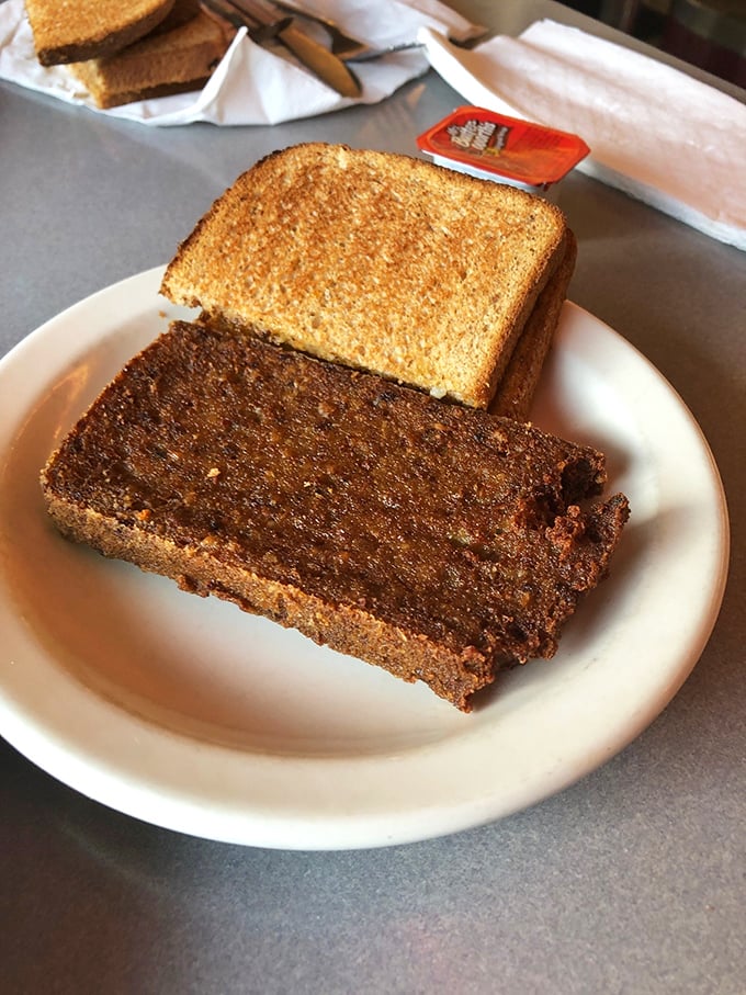 Behold the holy grail of Pennsylvania Dutch cuisine—perfectly crisped scrapple alongside golden toast. A breakfast worth crossing county lines for.