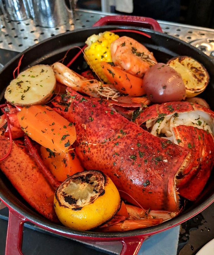 This isn't just a seafood boil—it's a celebration in a cast iron skillet. Lobster, shrimp, and charred lemons create a symphony of flavors that demands to be shared.