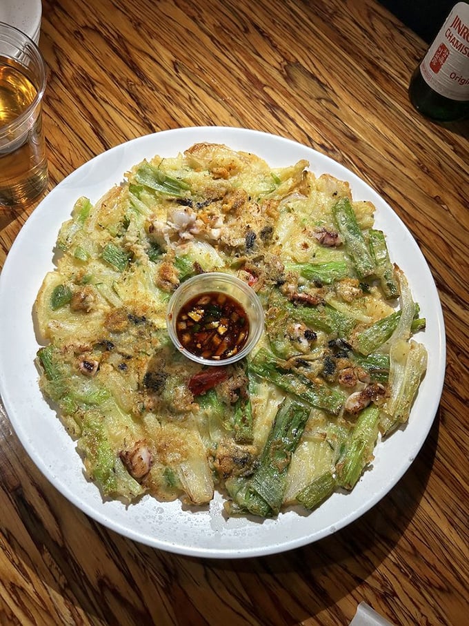 Behold the haemul pajeon in all its glory! Crispy exterior, tender seafood treasures within – this pancake doesn't need maple syrup, just your undivided attention.