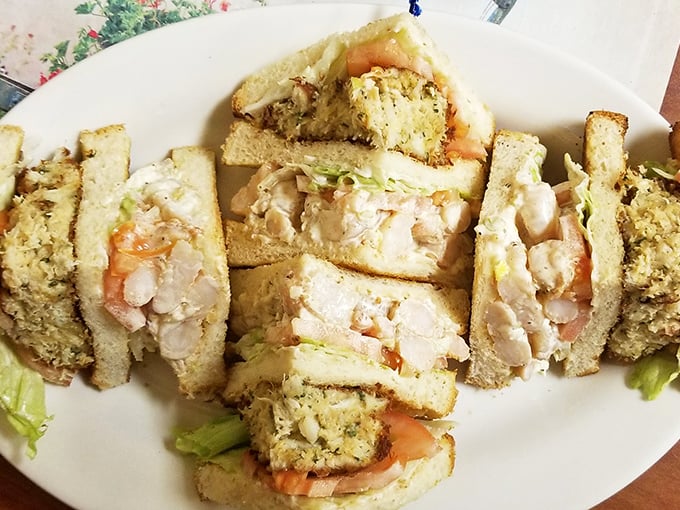 This seafood club sandwich doesn't just satisfy hunger – it's architectural genius stacked between toasted bread, Maryland-style.