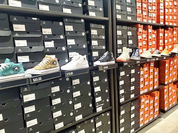 Walls of athletic shoes create a sneakerhead's paradise where every step leads to another perfect pair.