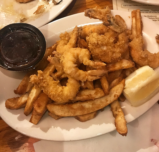The star attraction arrives: golden-battered shrimp nestled among perfectly crisp fries – a combination that's sparked more joy than Marie Kondo ever could.