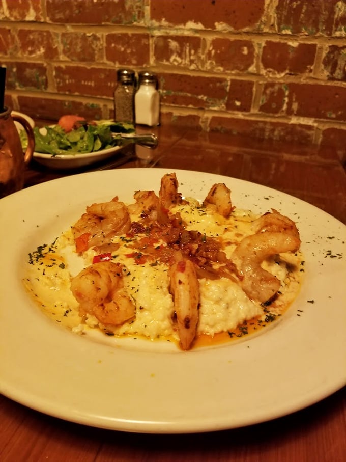 Shrimp and grits elevated to an art form – plump crustaceans crowning a creamy canvas of cheese-laden comfort that would make any Southerner weep with joy.