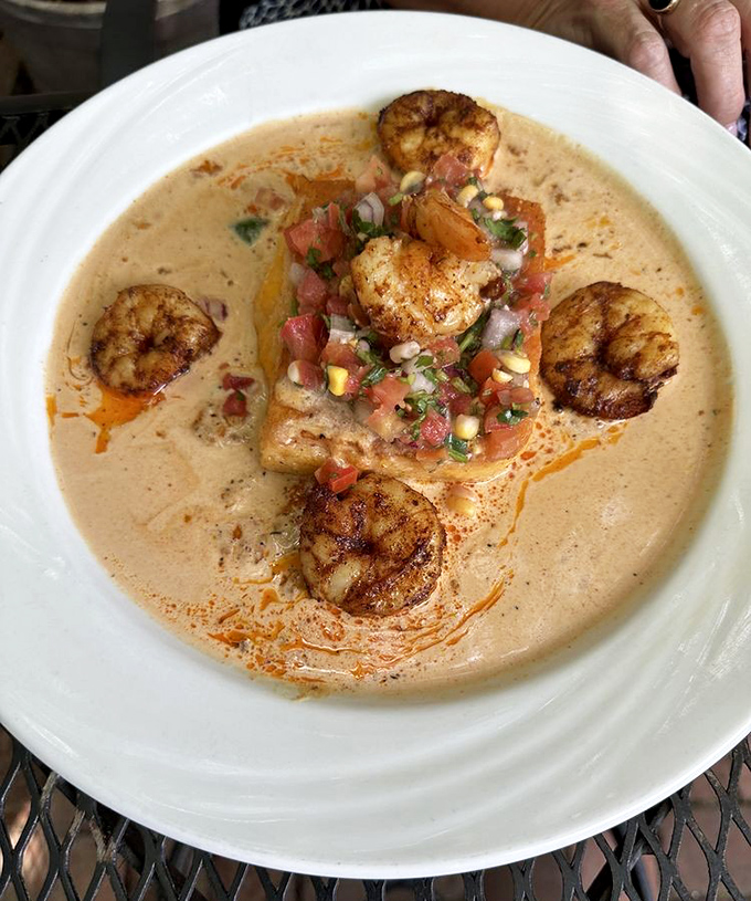 Shrimp and grits that could make a Southerner weep with joy—perfectly seared shrimp swimming in creamy heaven with fresh pico de gallo.