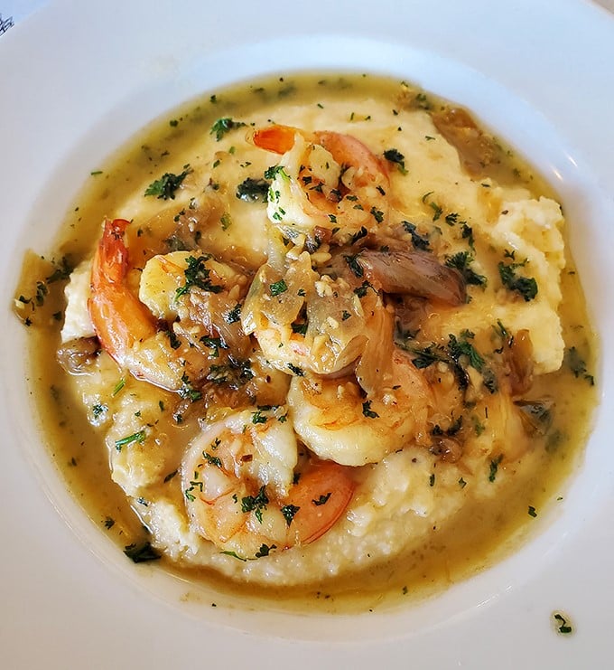 Shrimp and grits so good they'll make you want to hug the chef. Plump Gulf shrimp nestled on creamy stone-ground grits—comfort food elevated to an art form.
