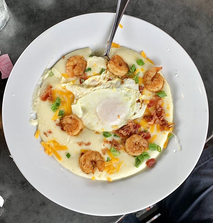 Behold the legendary Red's Shrimp & Grits—where plump shrimp and creamy grits unite in a marriage so perfect it should have its own reality show.