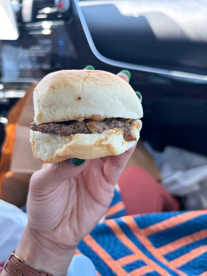 Behold the humble slider in its natural habitat—a perfect palm-sized portion of beef and onion bliss worth every mile driven.
