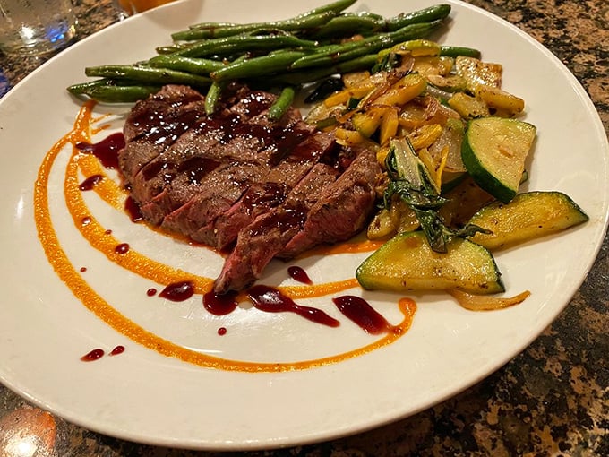 This isn't just dinner—it's edible artwork. The perfectly seared sirloin with colorful vegetables and artful sauce drizzles proves eating with your eyes comes first.