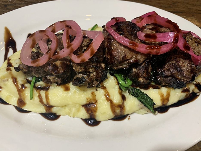 The sirloin tips—oh my!—resting on a cloud of mashed potatoes with those pickled red onions adding that perfect zing. Food architecture at its finest.