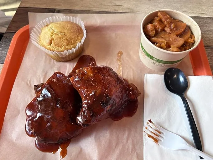 Glistening with sauce and paired with cornbread and candied yams, these ribs aren't just food—they're edible proof that patience is indeed a virtue.