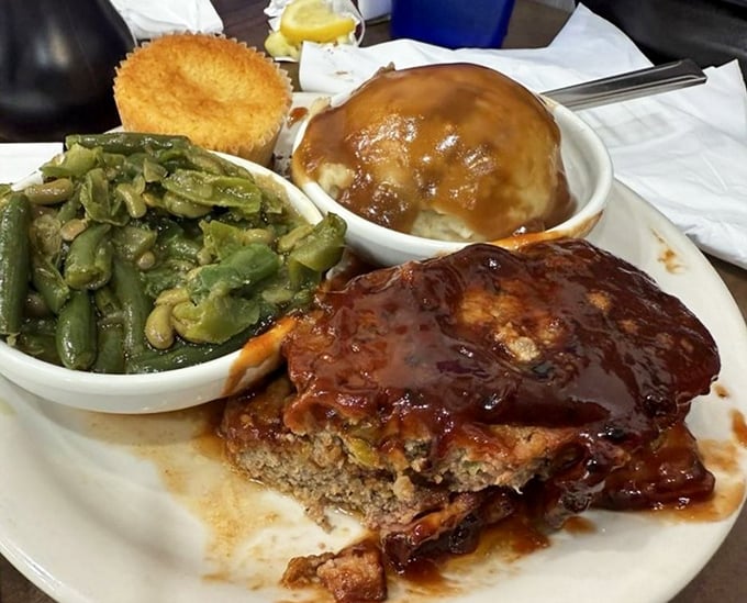 Behold the star attraction: smoked meatloaf that doesn't just fall apart - it practically surrenders to your fork with smoky, saucy dignity.