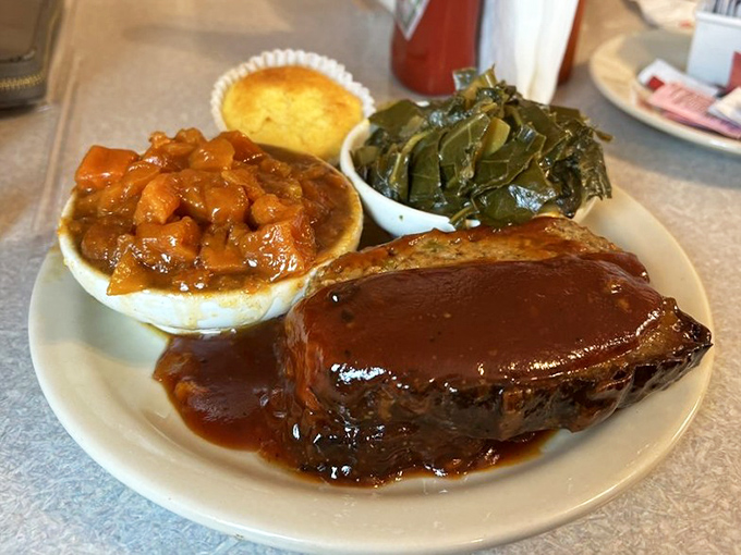 This isn't your mother's meatloaf—it's better. Hickory-smoked perfection swimming in house-made sauce with collards and candied yams.