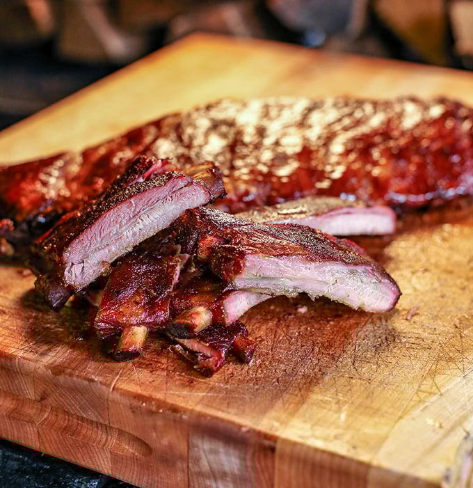 These ribs don't just fall off the bone—they leap willingly into your mouth with smoky enthusiasm.