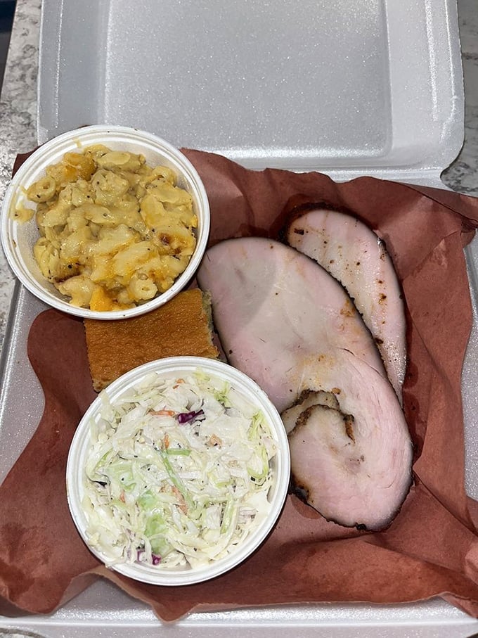 Behold the star of the show! Perfectly smoked turkey slices with mac and cheese and slaw – a trio that makes you wonder why turkey is relegated to just Thanksgiving.