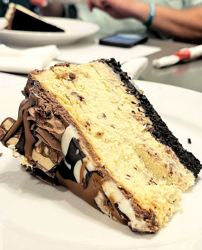This isn't just cake, it's architecture – layers of vanilla, chocolate, and Oreo crust creating the Taj Mahal of dessert experiences.