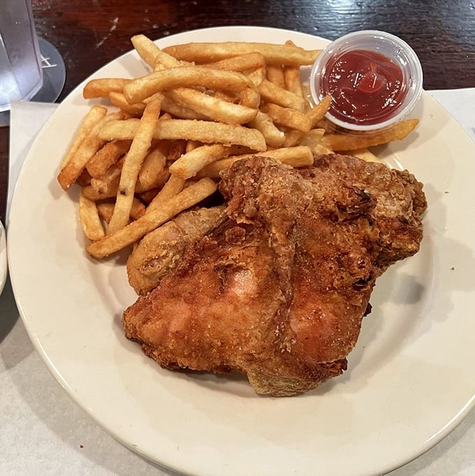 Behold the star of the show: golden-brown fried chicken that shatters with each bite. This isn't just dinner—it's a religious experience with extra napkins.