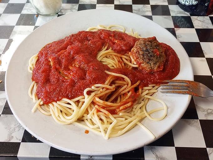 Spaghetti that would make your Italian grandmother nod in approval—a mountain of pasta swimming in sauce that's clearly been simmering since breakfast.
