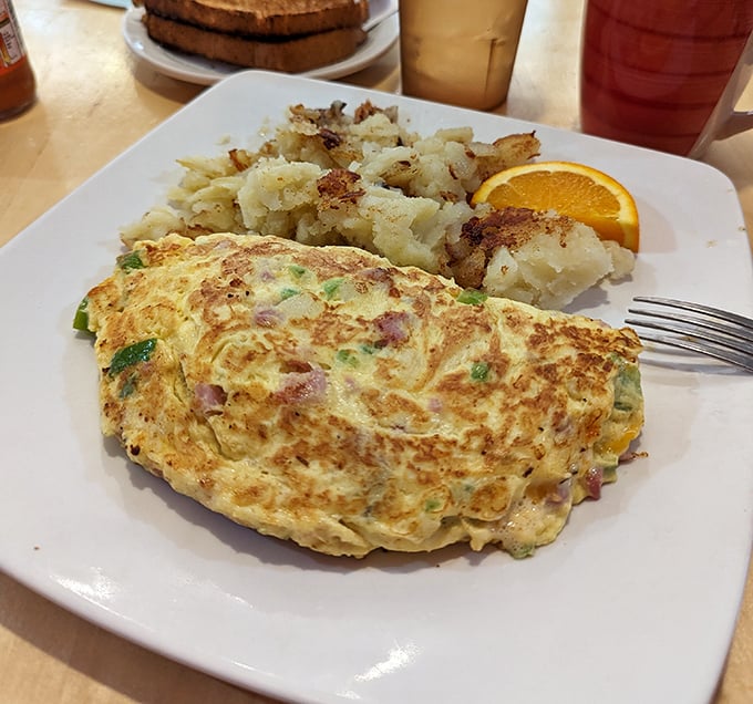 This Spanish Omelet doesn't just sit on the plate—it lounges confidently beside those golden home fries like it knows it's the star.