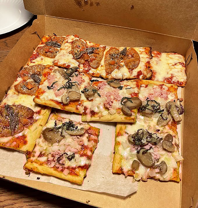 Square pizza perfection in its natural habitat – the distinctive shape means more crispy edges and perfect cheese-to-sauce ratio in every magnificent bite.