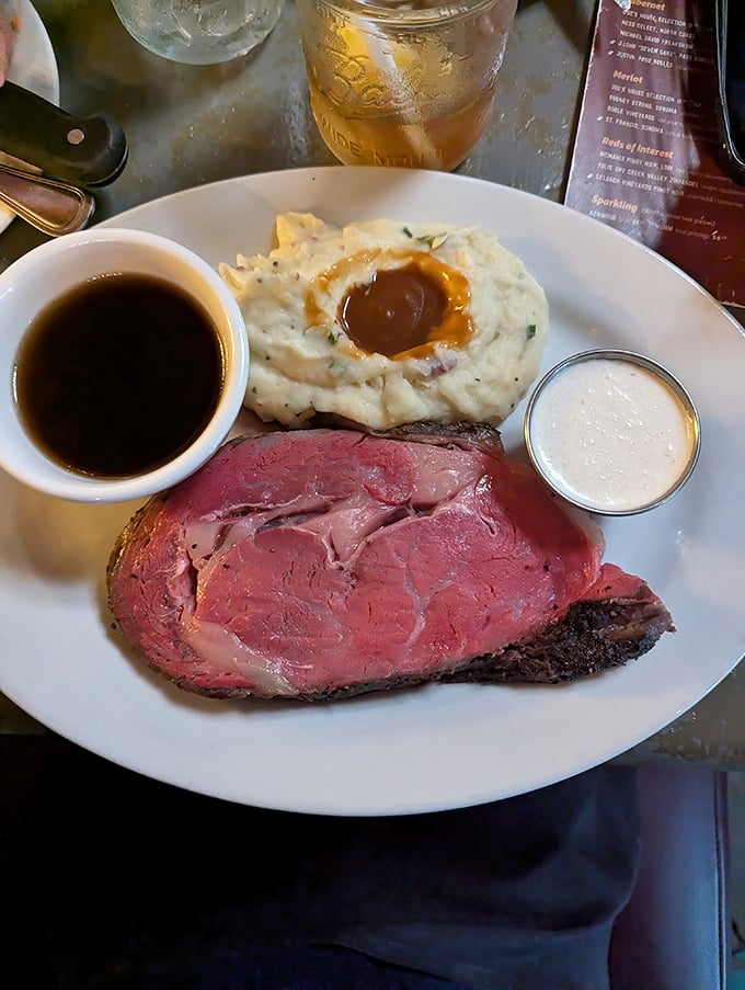This perfectly medium-rare prime rib isn't just dinner—it's a religious experience with gravy. The crater of mashed potatoes could solve California's water storage issues.