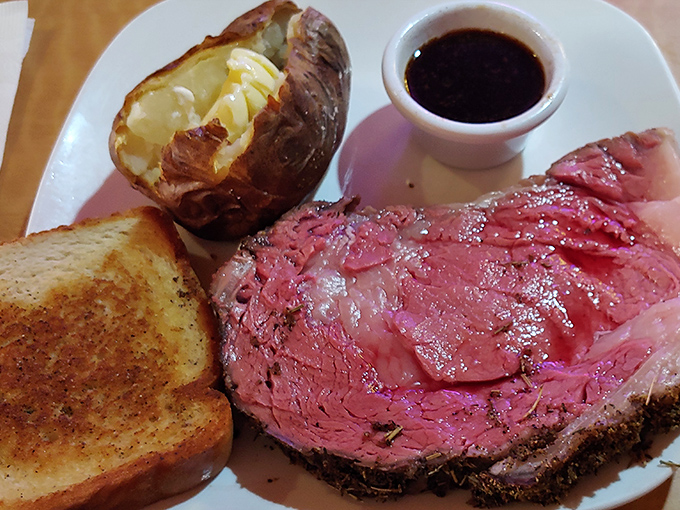Prime rib so perfectly pink it could make a vegetarian weep. That loaded baked potato and garlic toast aren't just sides—they're supporting actors in a meaty masterpiece.