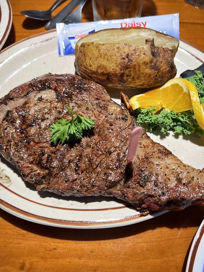 This isn't just a steak—it's a masterpiece of marbling that makes grown adults go silent mid-conversation. The baked potato stands by, knowing its supporting role.
