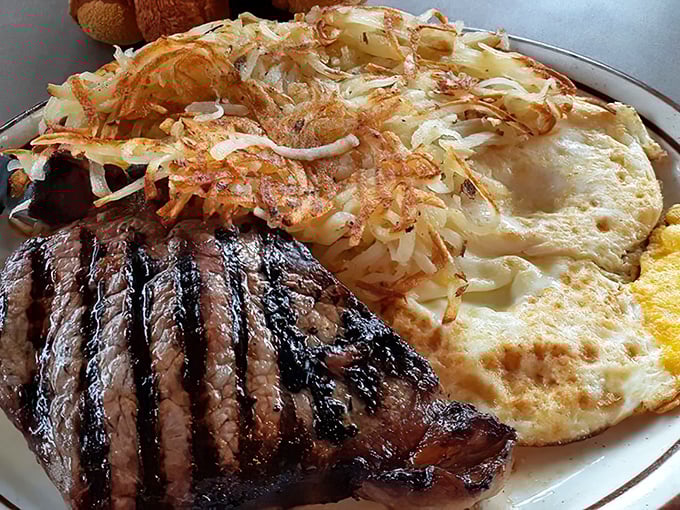 This isn't just steak and eggs; it's the breakfast equivalent of a standing ovation. Those perfectly crispy hash browns deserve their own fan club.