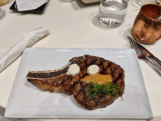 Perfectly seared with herb garnish - this porterhouse proves that sometimes the simplest presentations create the most memorable moments.