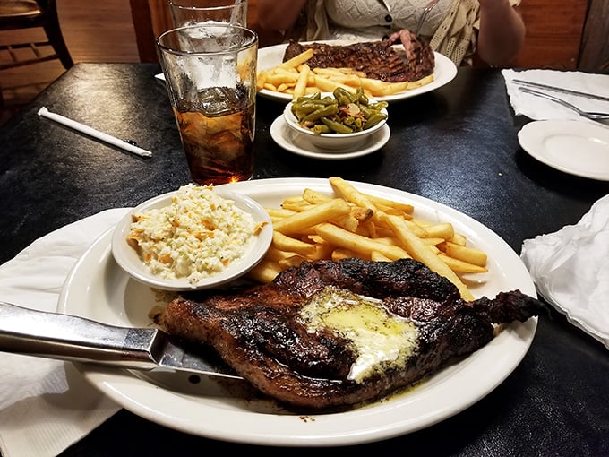 That's not just a steak—it's a masterpiece of marbling with a side of coleslaw that somehow manages to hold its own against the beefy star. 