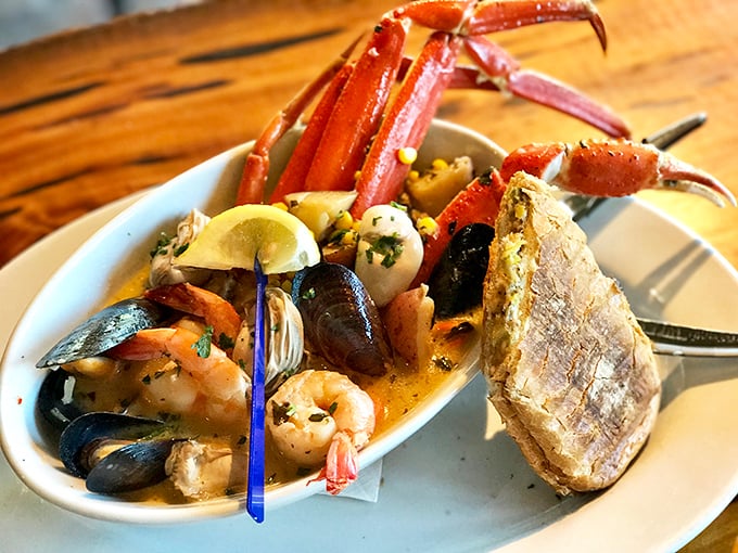 Seafood stew that could make Neptune himself jealous. Crab legs reaching skyward like they're trying to escape, but trust me—you'll want them on your fork.