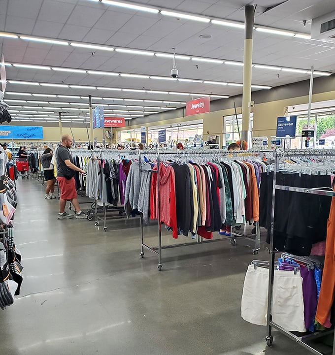 The clothing section stretches toward the horizon, a kaleidoscope of fashion possibilities organized by color and category.