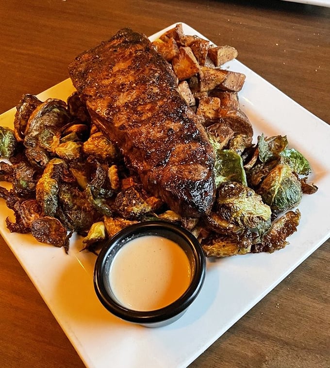 This isn't just a steak—it's a masterpiece of meat artistry served with Brussels sprouts that might finally make peace with your childhood vegetable trauma.