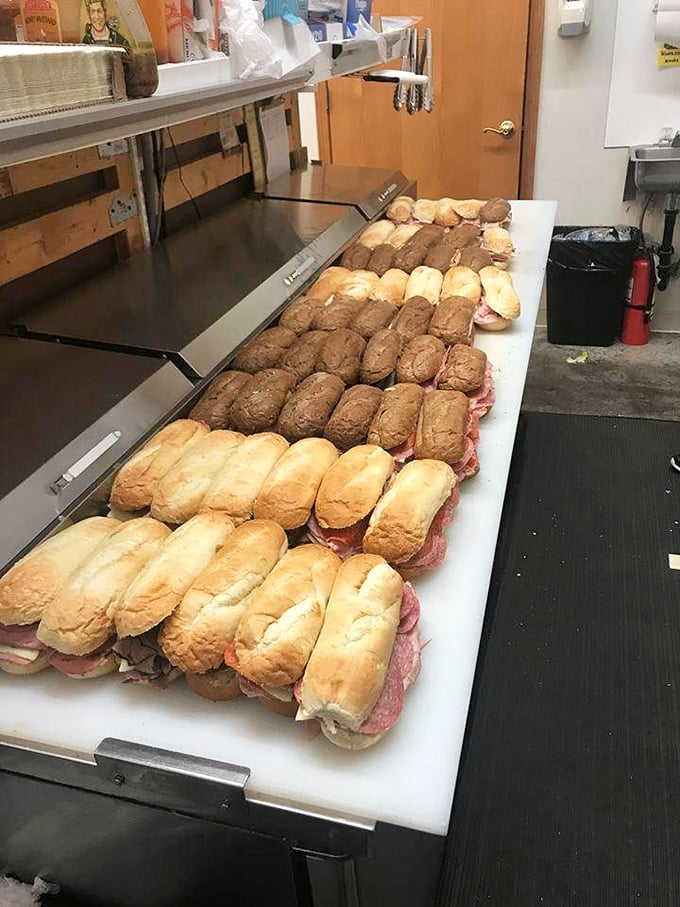 Sandwich perfection in progress – these freshly assembled subs lined up like soldiers ready to battle hunger with their arsenal of quality ingredients.