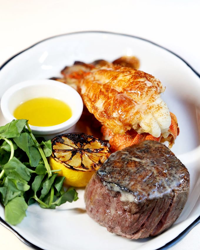 The surf and turf arrives like royalty on fine china—a perfectly seared filet alongside a lobster tail that practically winks at you.