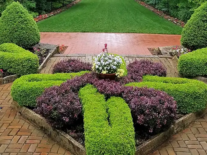 Garden geometry at its finest—these precisely trimmed hedges and colorful plantings prove that sometimes nature looks best when given a little artistic direction.