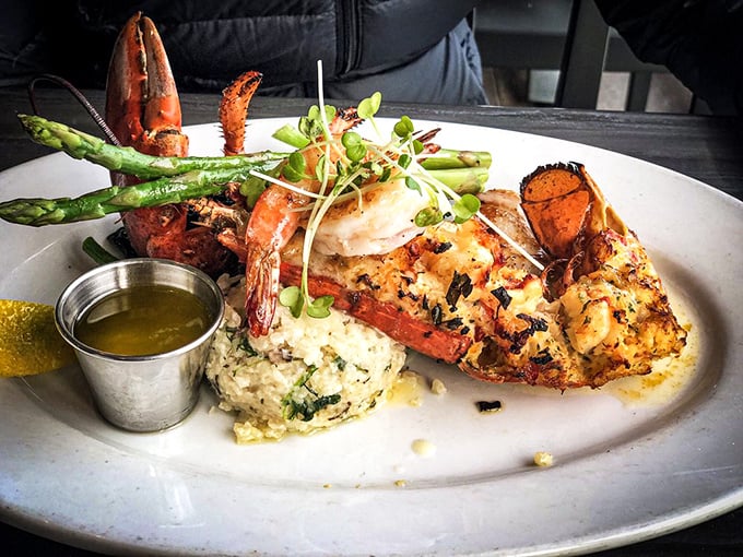 The lobster tail arrives like royalty—butterflied, broiled to perfection, and escorted by asparagus spears standing at attention. Butter cup salutes on command.