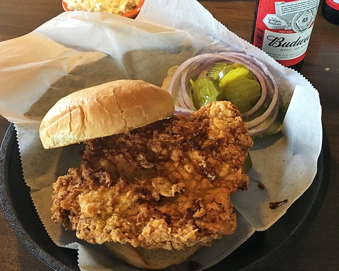 Behold the star attraction: a tenderloin so perfectly breaded it extends well beyond its bun—a true Iowa handshake in sandwich form.