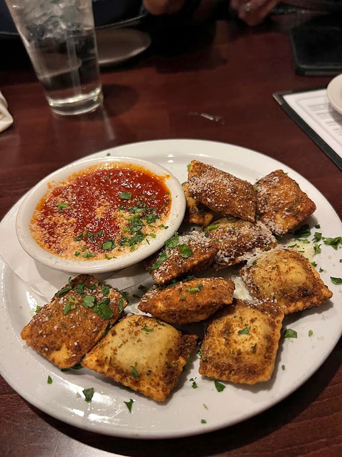 Behold the crown jewel: golden-brown toasted ravioli dusted with parmesan, served with marinara that demands to be savored with every bite.