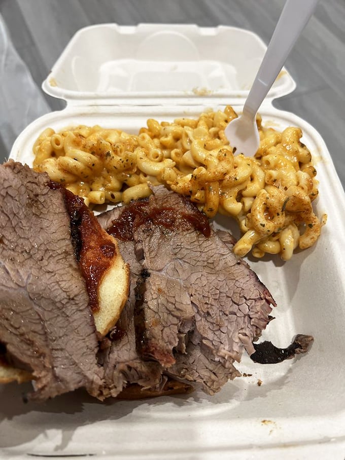 Behold the star of the show—tri-tip sliced to perfection with mac and cheese that's clearly been taking its comfort food responsibilities seriously.