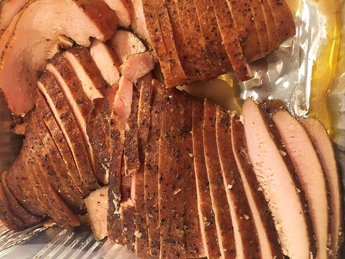 Smoked turkey that defies physics – somehow remaining impossibly moist. Each slice carries the perfect balance of smoke and spice, a poultry masterpiece.