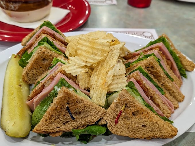 Behold the legendary turkey club in all its triple-decker glory, where each perfectly toasted triangle reveals architectural sandwich mastery.