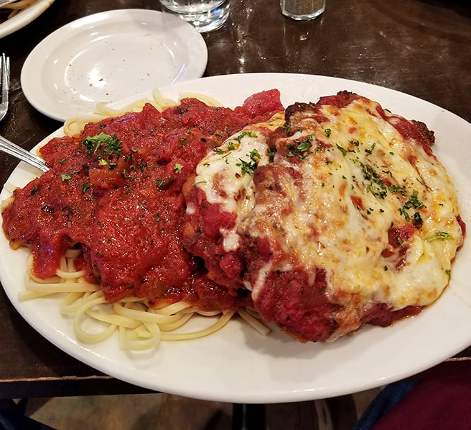 Behold the legendary Veal Parmigiano—tender meat, vibrant sauce, and cheese melted to perfection. Resistance is futile.