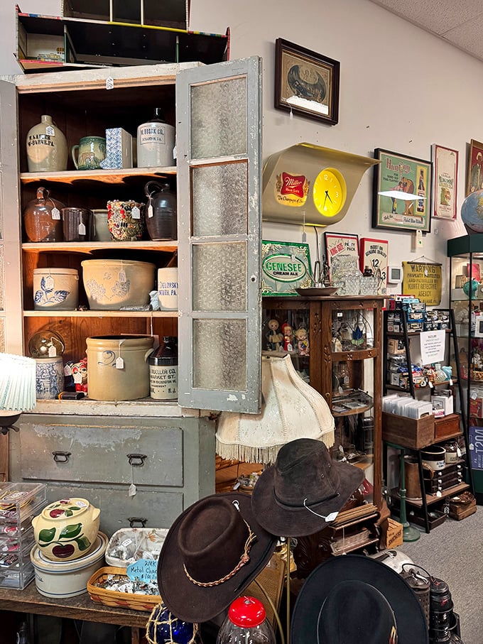 This isn't just furniture – it's time travel. Vintage cabinets displaying Pennsylvania pottery, antique crocks, and cowboy hats that have seen more adventures than most of us.